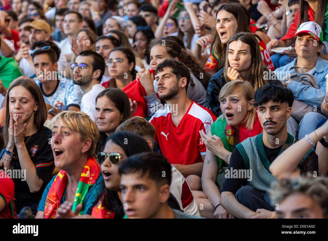 Portugal fans react while watching on a giant outdoor screen at Amor de ...