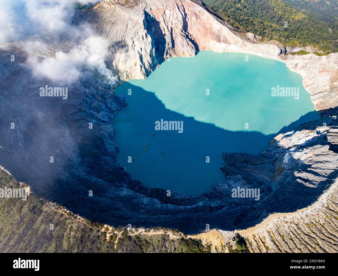 Aerial view Kawah Ijen volcano with turquoise sulfur water lake at sunrise.Amazing nature ...