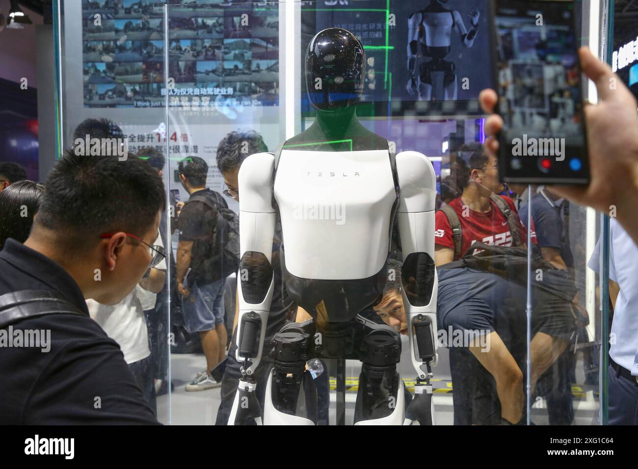 Visitors check out Tesla's second-generation Optimus humanoid robot ...
