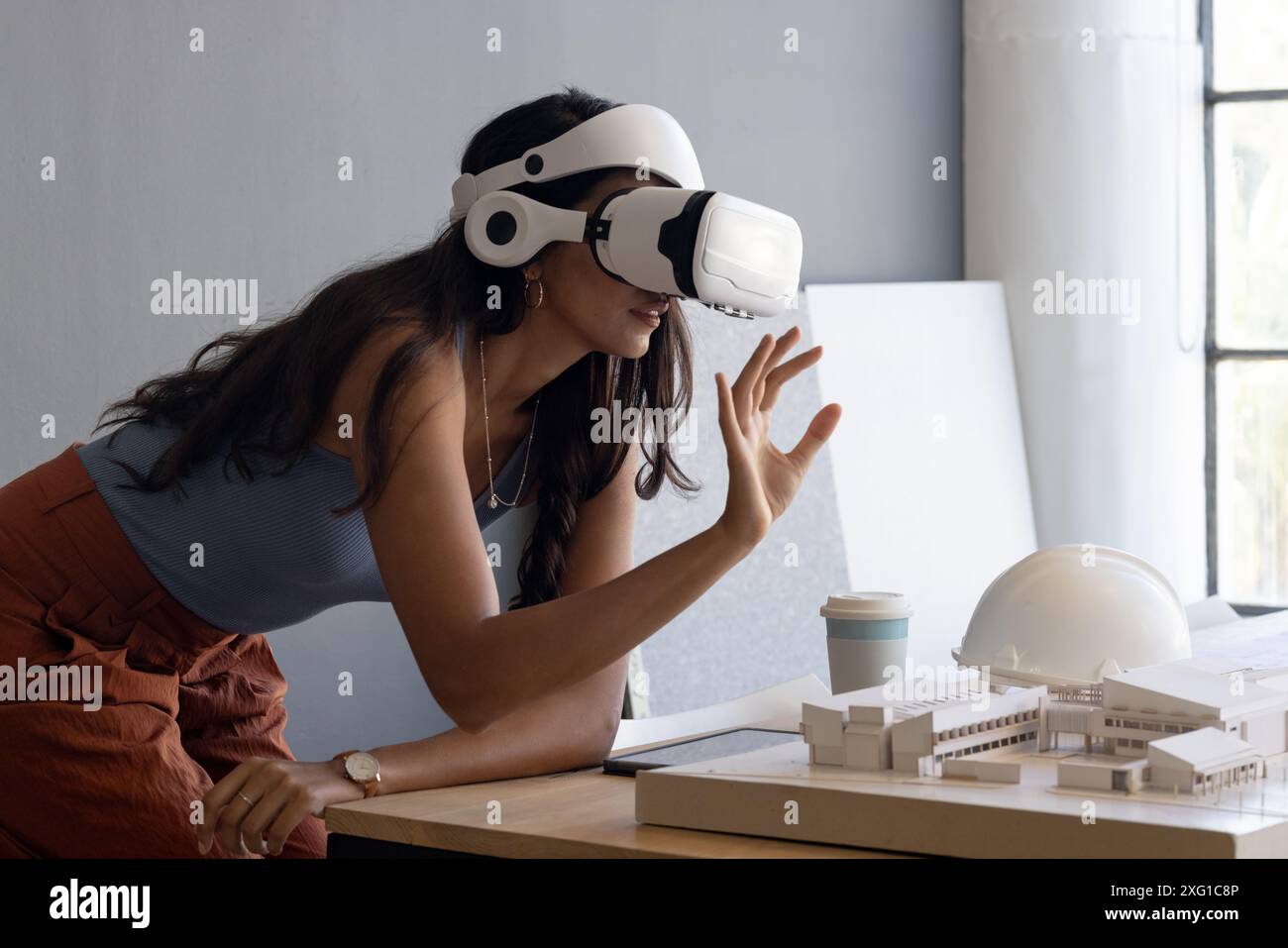 Using VR headset, woman interacting with architectural model in office, copy space Stock Photo ...