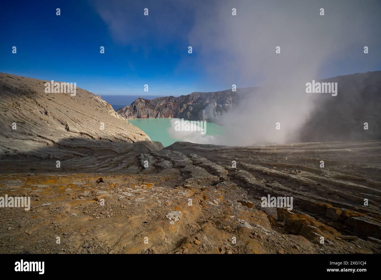 Aerial view Kawah Ijen volcano with turquoise sulfur water lake at sunrise.Amazing nature ...