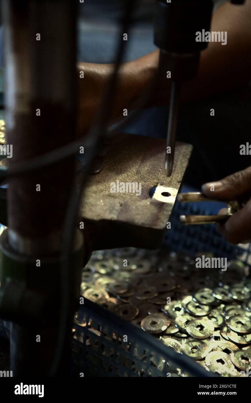 Production of traditional Balinese coins with hollow known as "pis ...