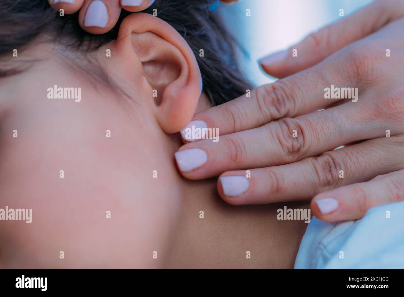 Paediatric endocrinologist , examining swollen lymph nodes of a young ...