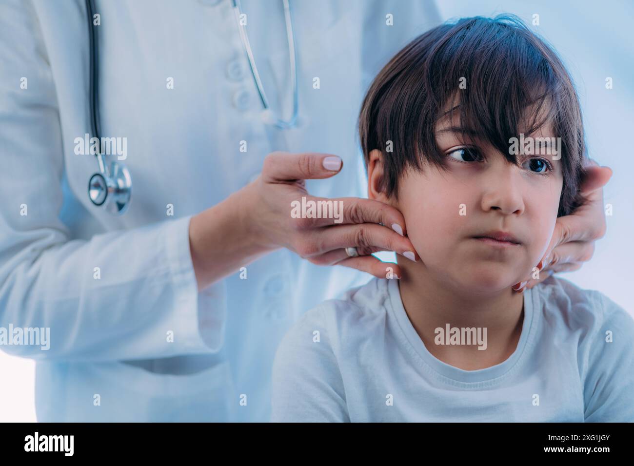 Paediatric endocrinologist examining a young boy's lymph nodes Stock ...