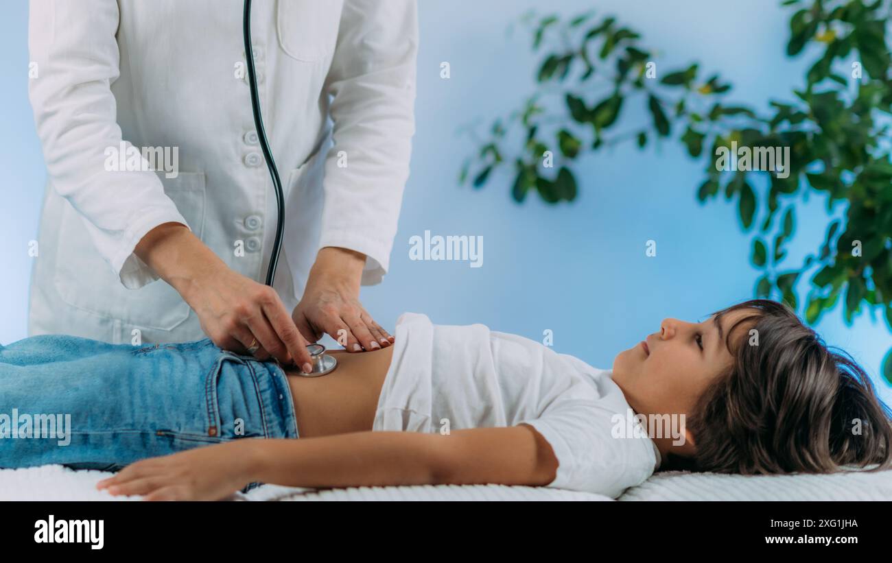 Pediatrician gastroenterologist doing abdominal examination with stethoscope Stock Photo - Alamy