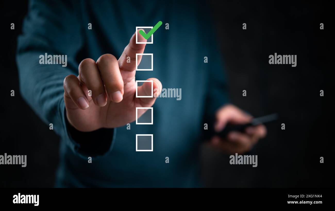 Hand touching checklist, green check mark highlighted. Concept of task ...