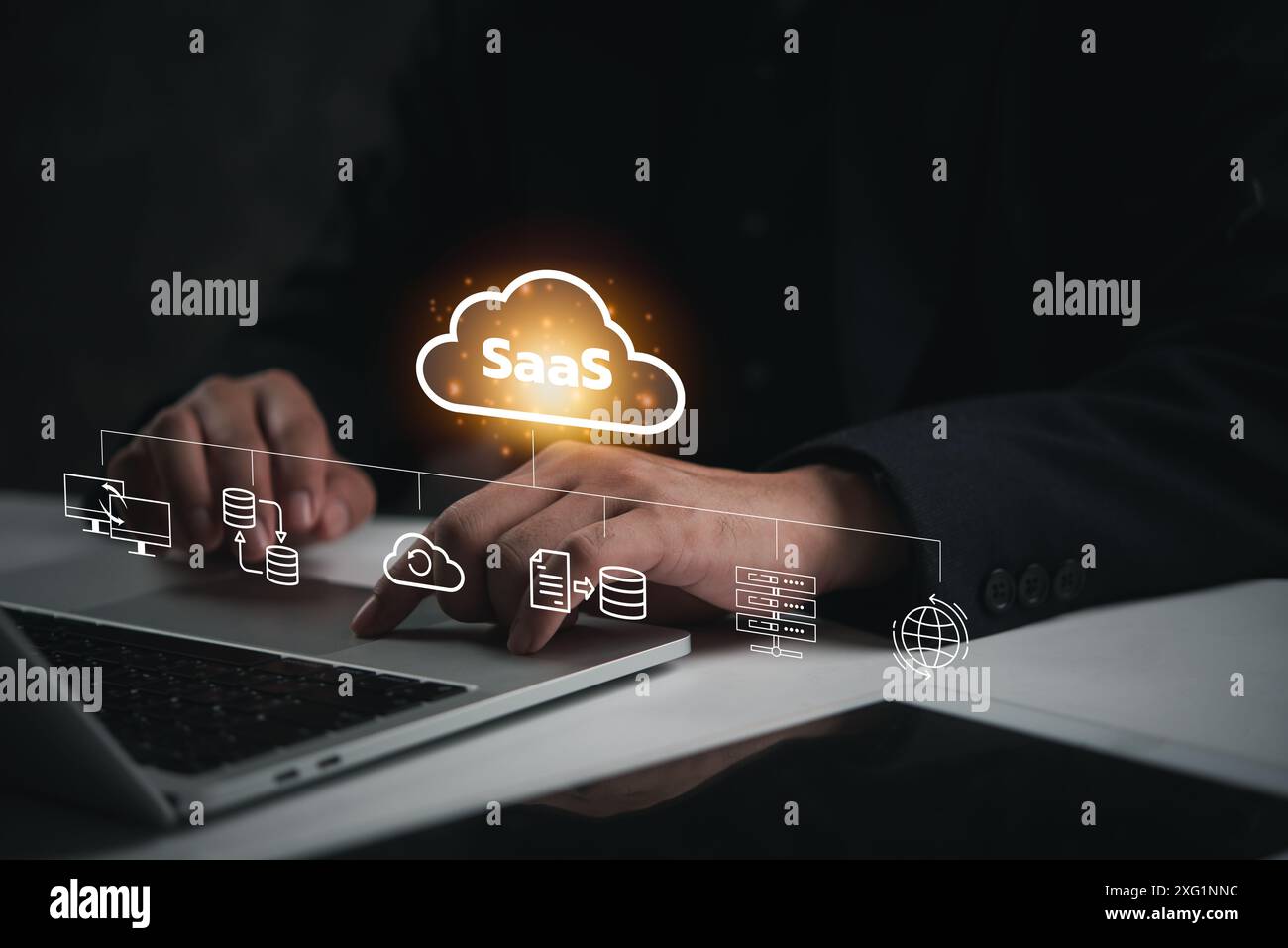 Hand interacting with SaaS icons above laptop, showcasing software as a ...