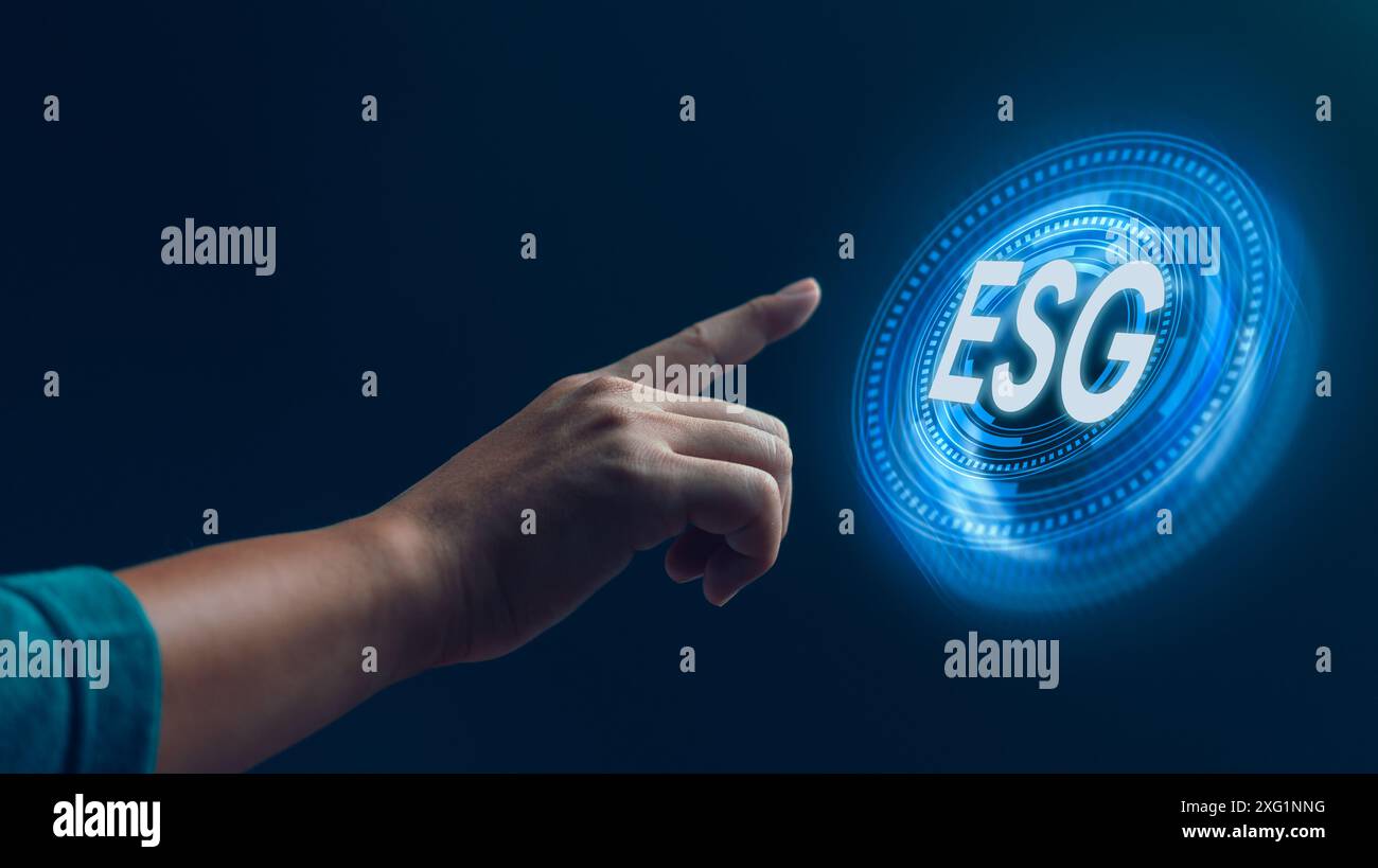 Hand pointing to glowing ESG hologram, representing environmental ...