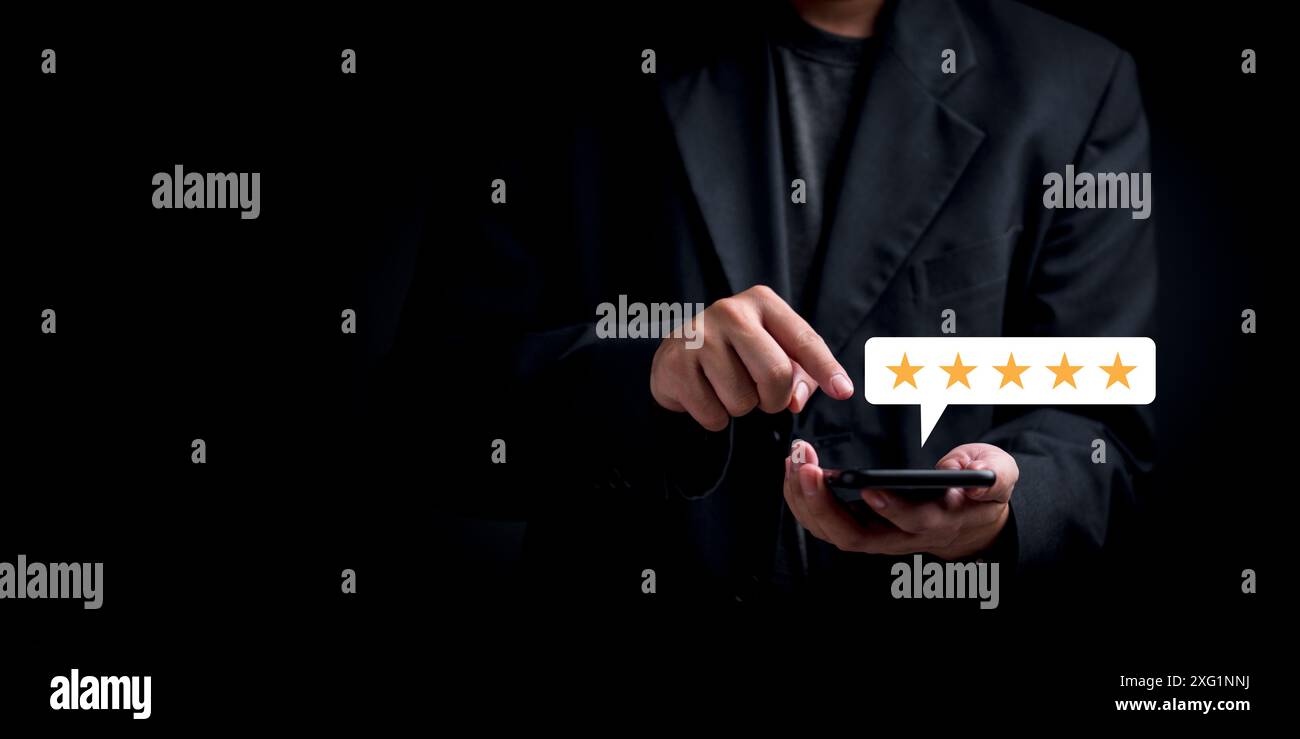 Businessman using smartphone to give five-star rating. Highlights ...