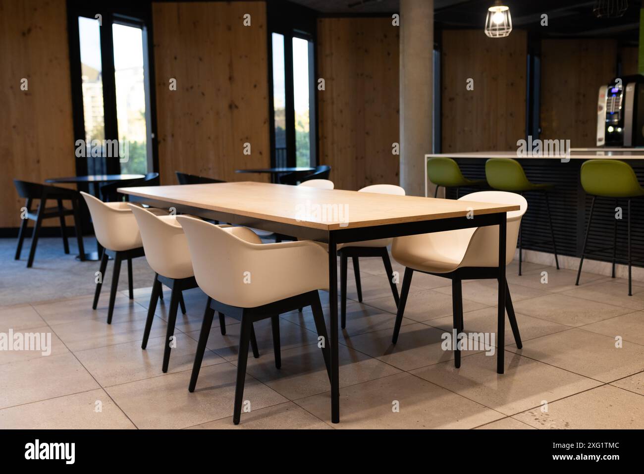 Modern office break room with empty chairs and table, ready for ...