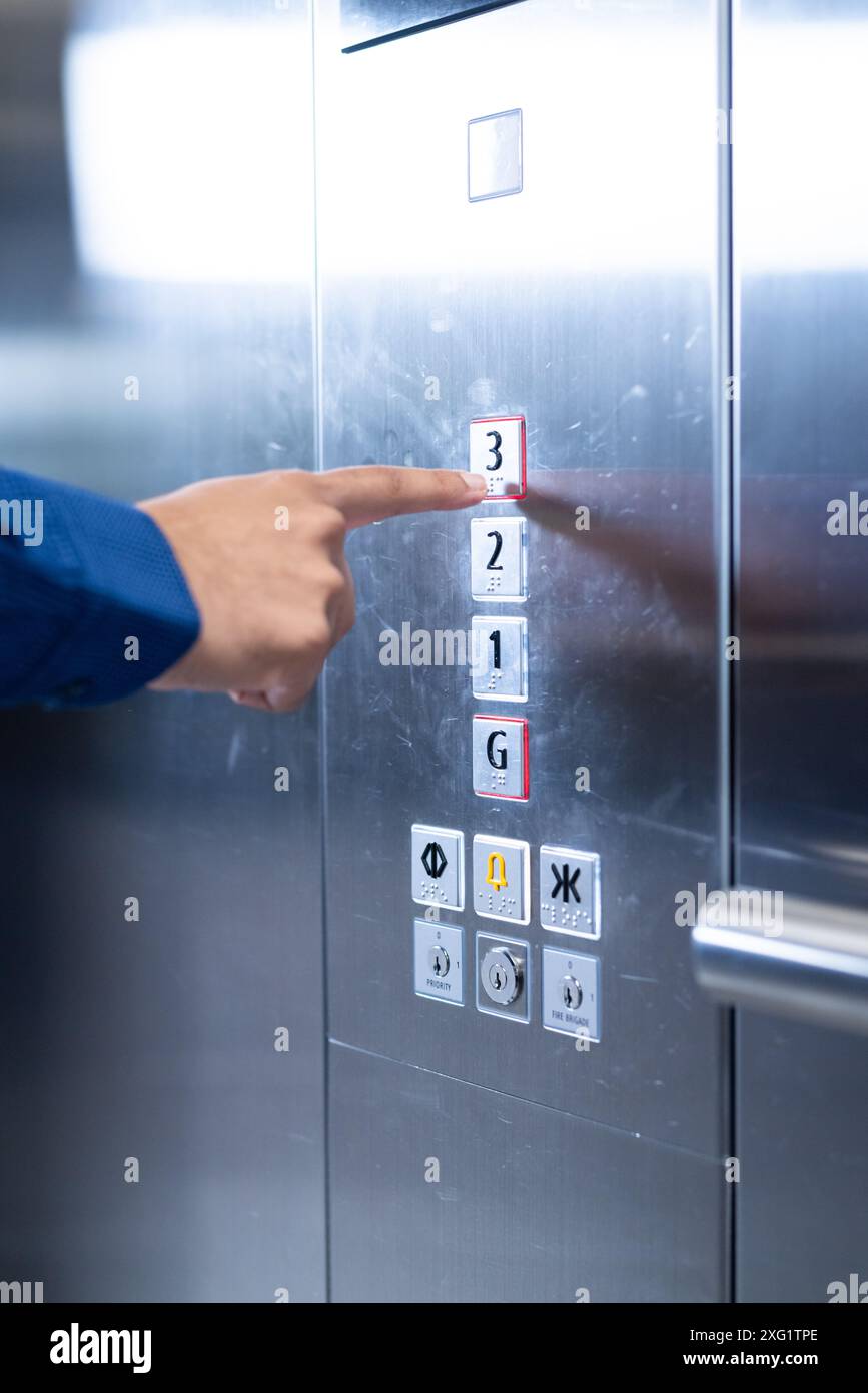 Pressing elevator button, person selecting third floor in modern office ...