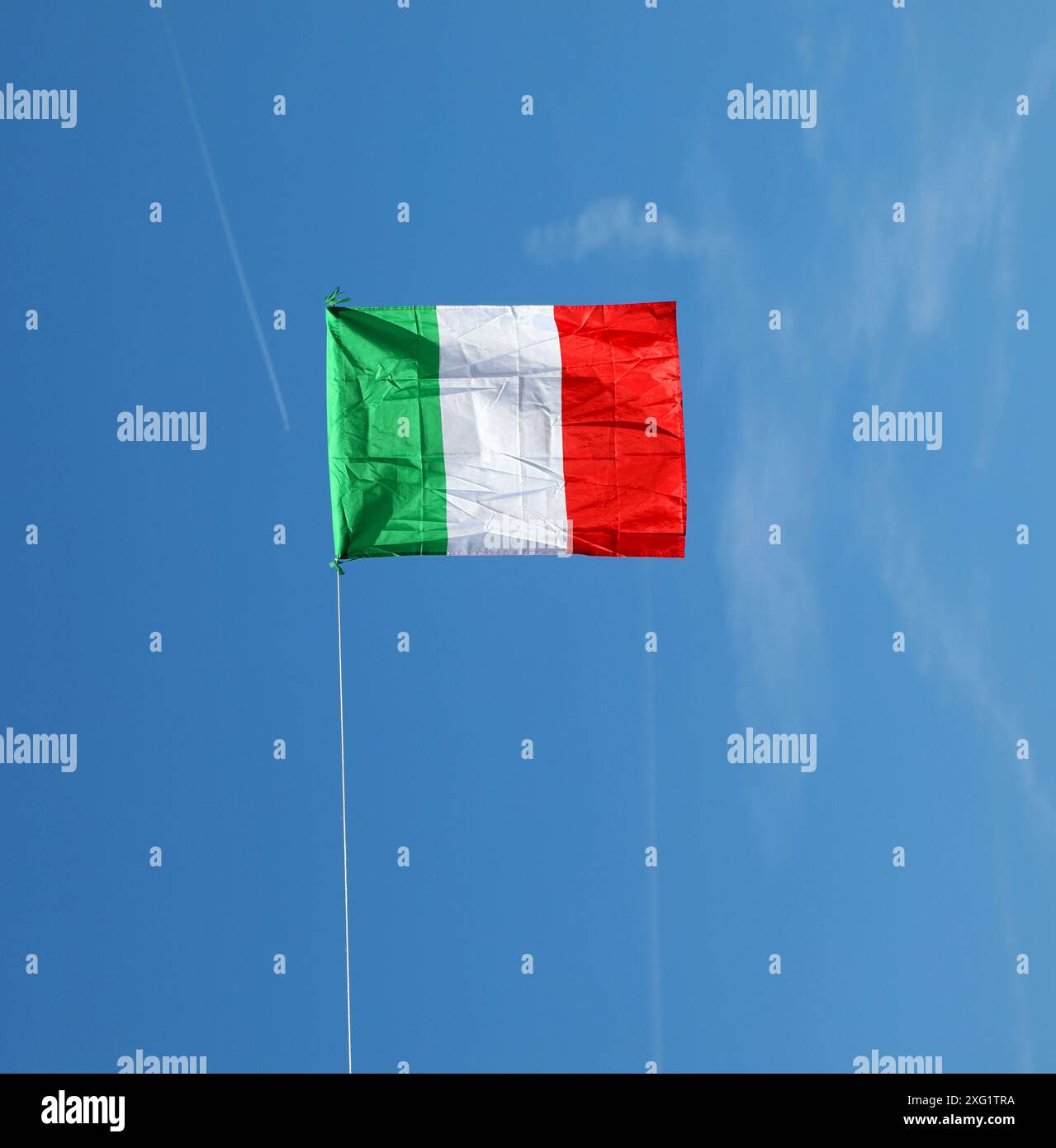 large Italian flag with green white and red stripes is waving in a ...