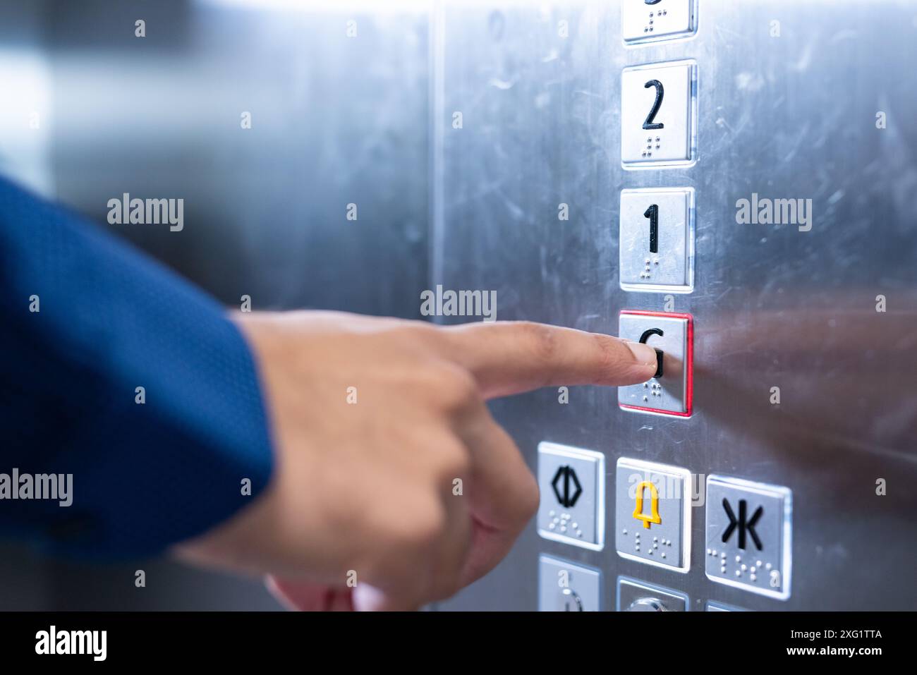 Pressing elevator button, person in business attire using elevator in ...