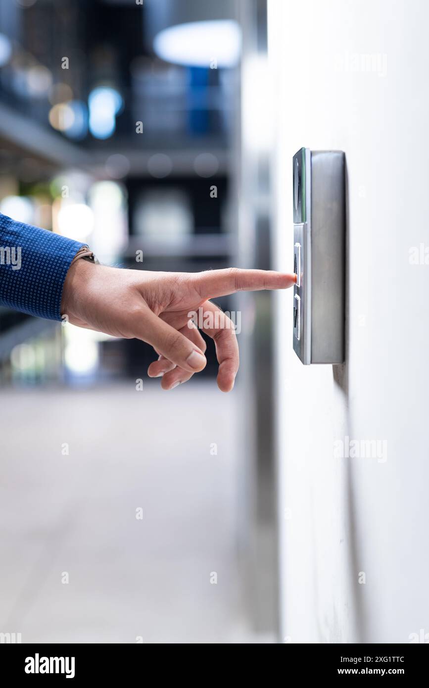 Pressing button on security keypad, person entering office building ...