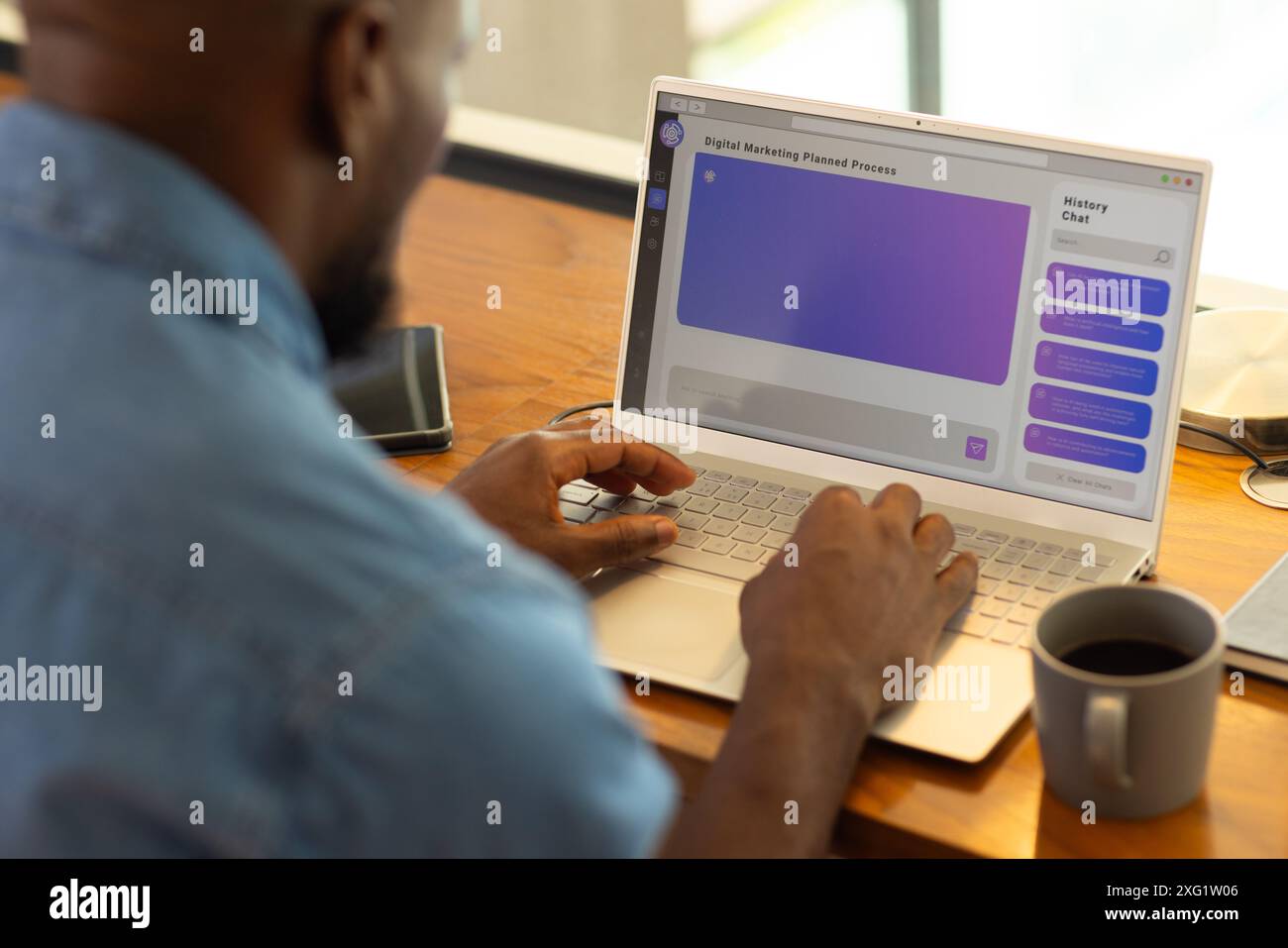 Using AI chatbot on laptop, man working on digital marketing project at ...