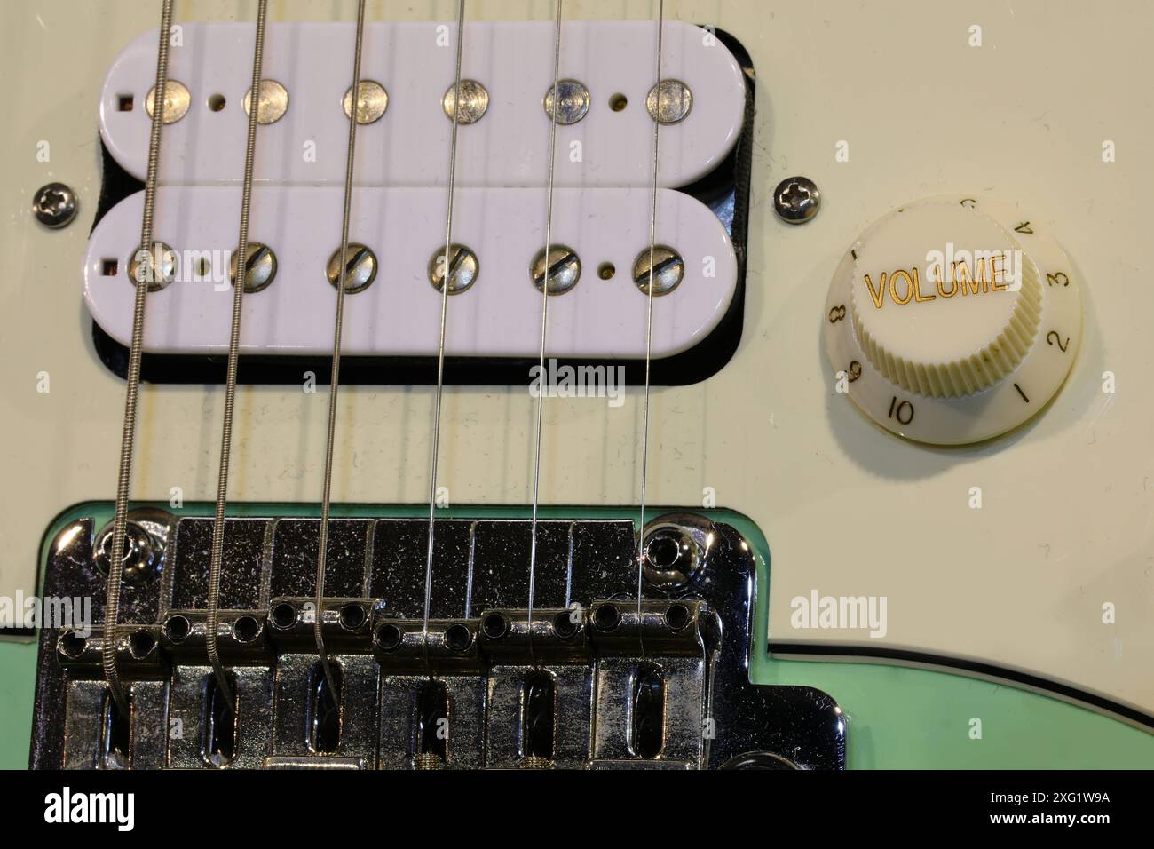 Vintage electric guitar volume knob and pickups under the six strings ...