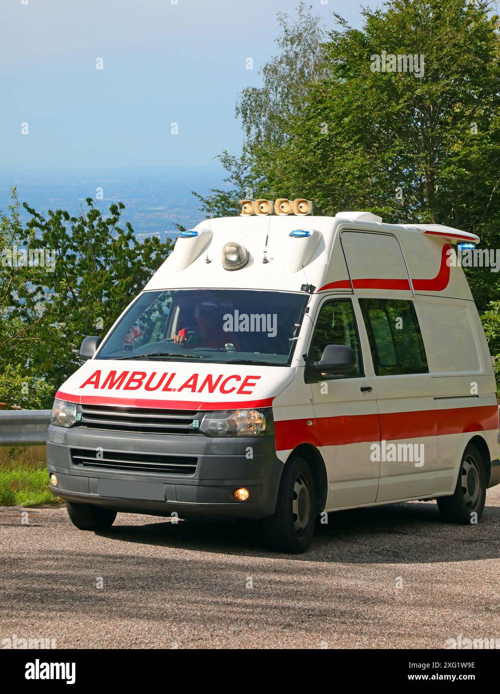 white emergency ambulance van with its lights flashing while responding ...