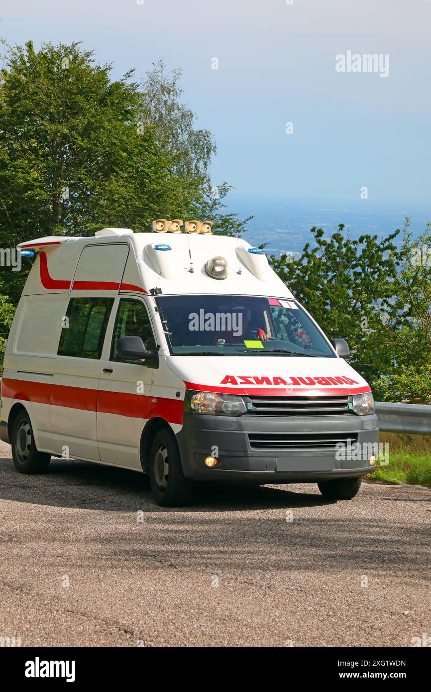while Ambulance van with the text AMBULANZA written backwards in ...