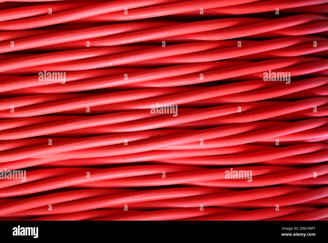 High voltage power line with thick red insulated cable against a ...