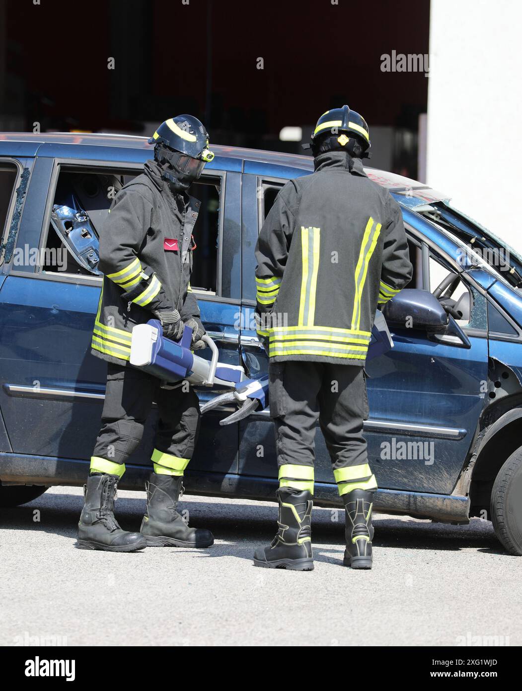 A firefighter using powerful cordless pneumatic shears to open the ...