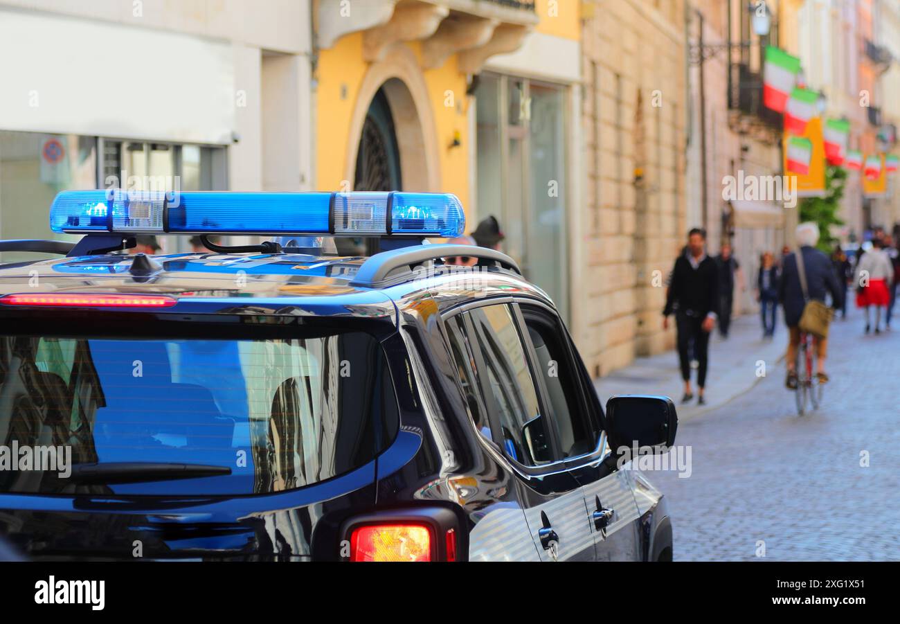 Police car with flashing blue lights patrolling city streets Stock ...