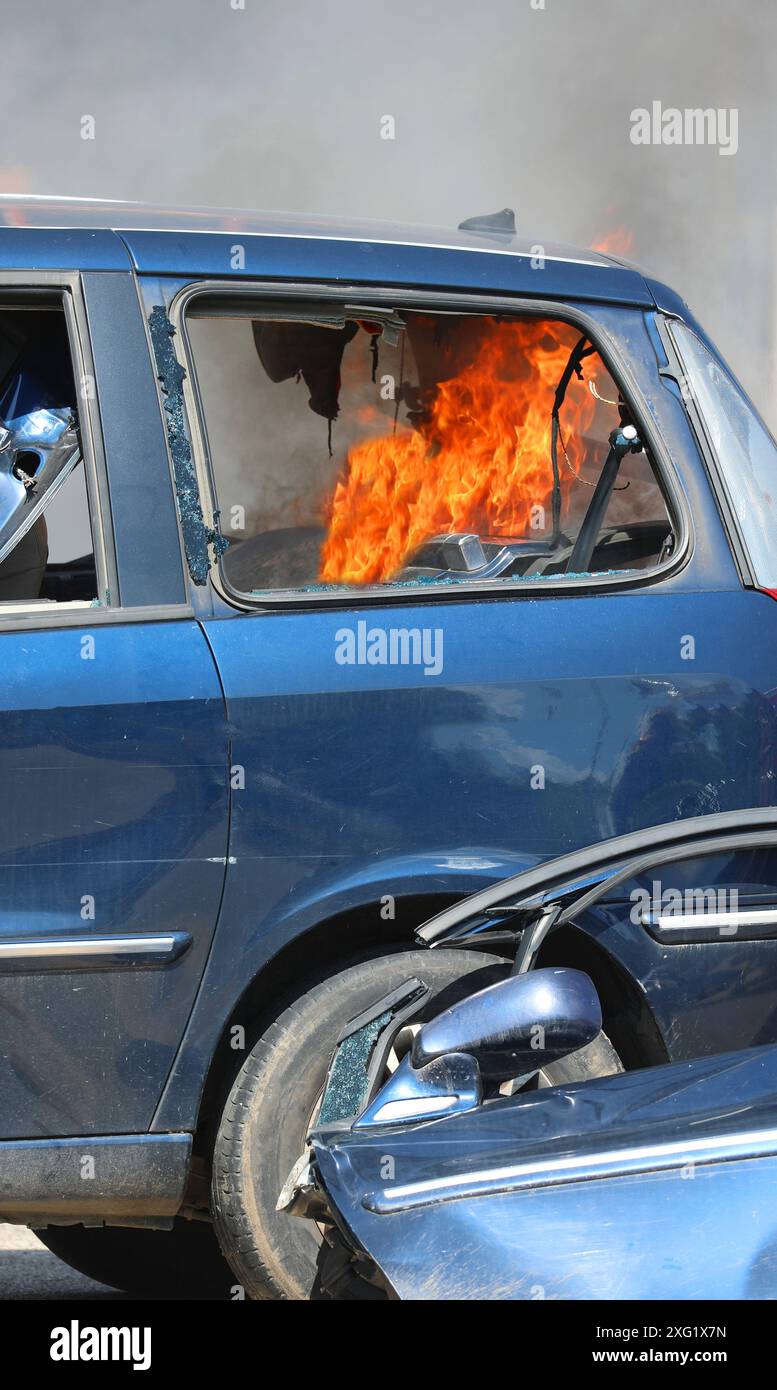 dangerous fire flames inside car trunk after road accident Stock Photo ...