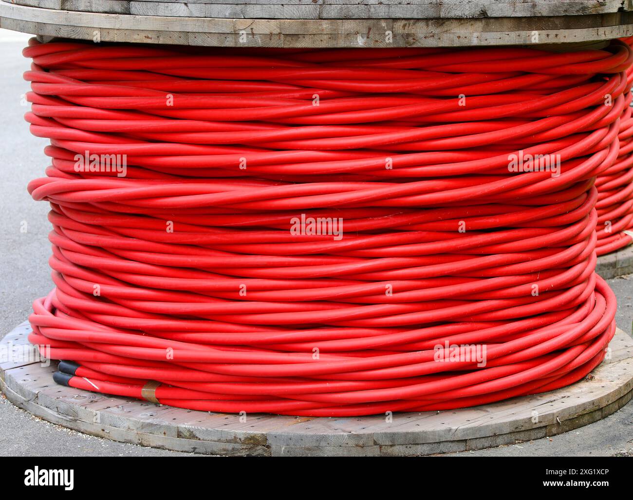 large reel of high voltage insulated red electrical cable in power ...