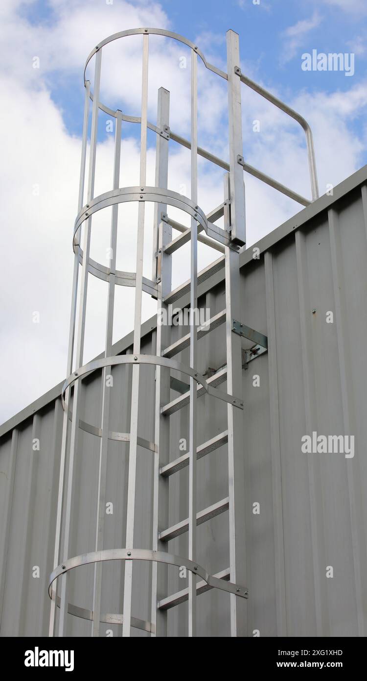 iron ladder with protective cage to climb onto the roof of the ...