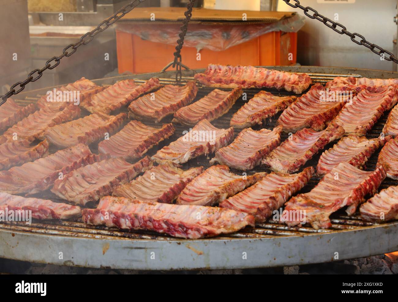 Grilled pork ribs in abundance at the industrial bbq restaurant without ...