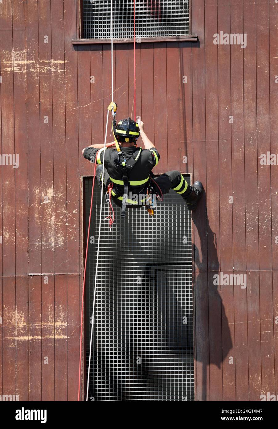 intrepid firefighter lowering himself from the building during the ...