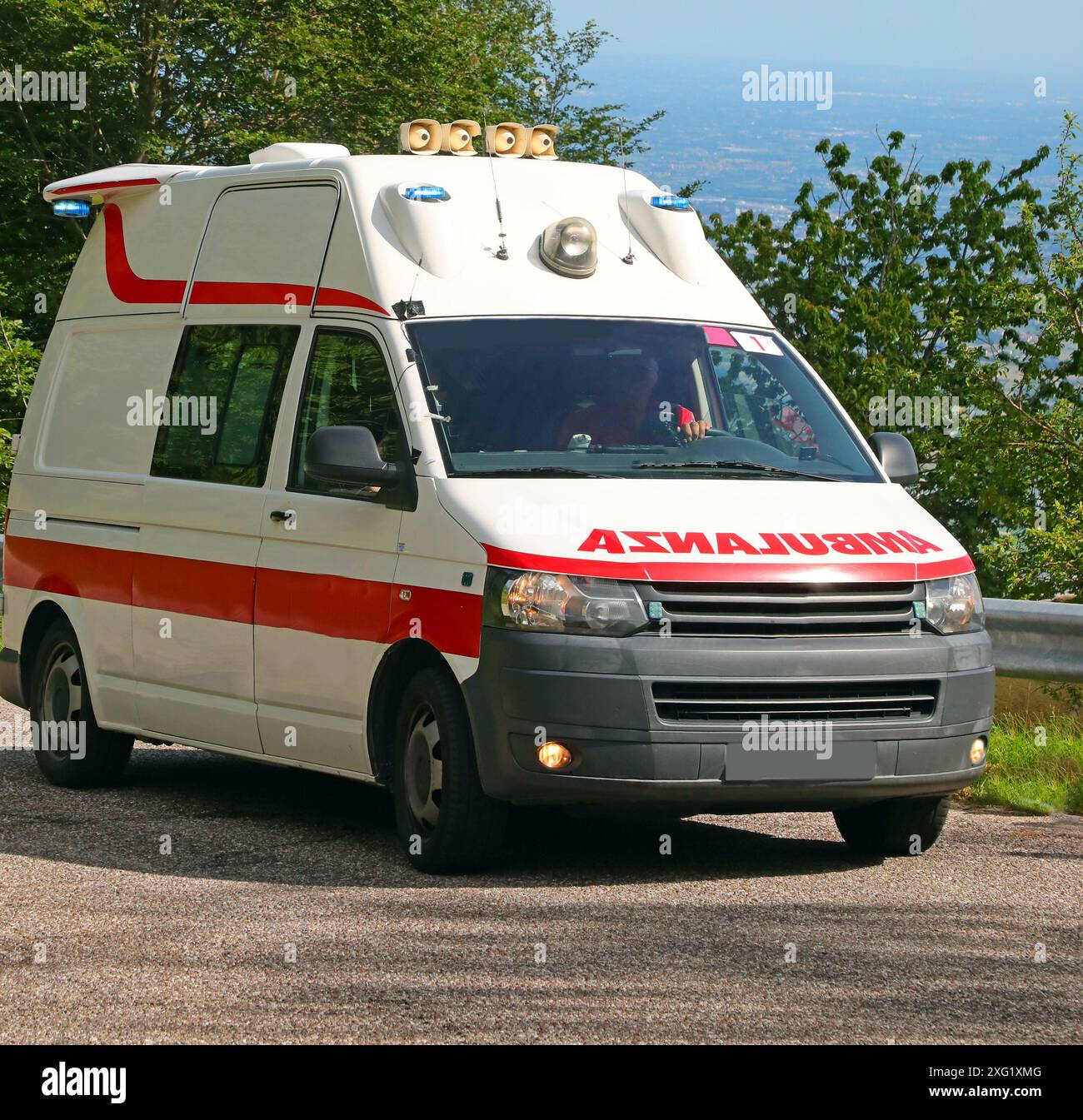 white emergency van with the word AMBULANZA spelled backward so that it ...