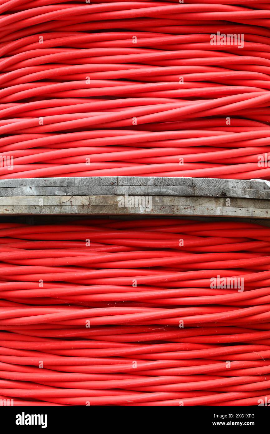two spools of red high-voltage insulated cable for transmitting ...