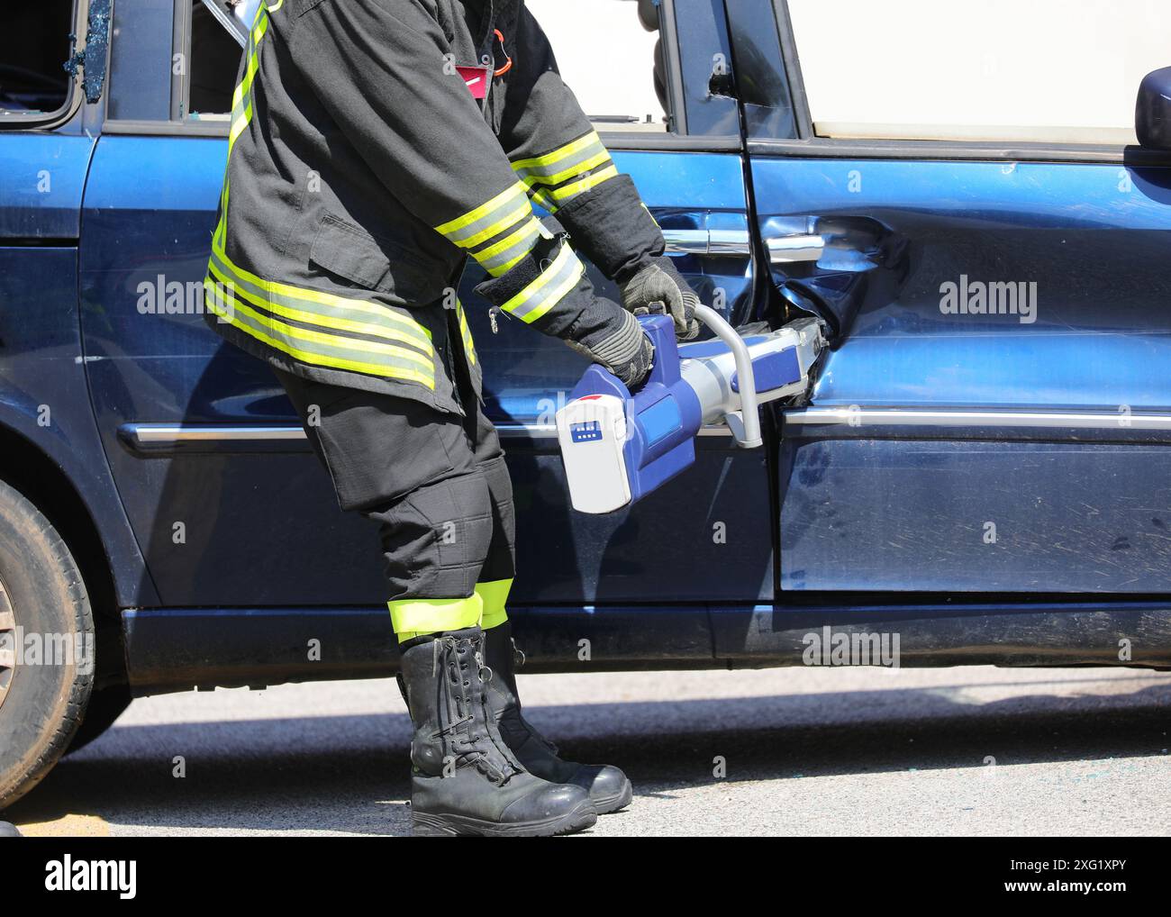 firefighter using powerful cordless pneumatic shears to open the jammed ...