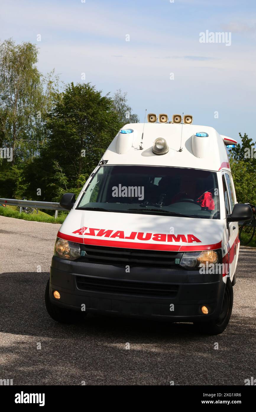 white emergency van with the italian text AMBULANZA spelled backward so ...