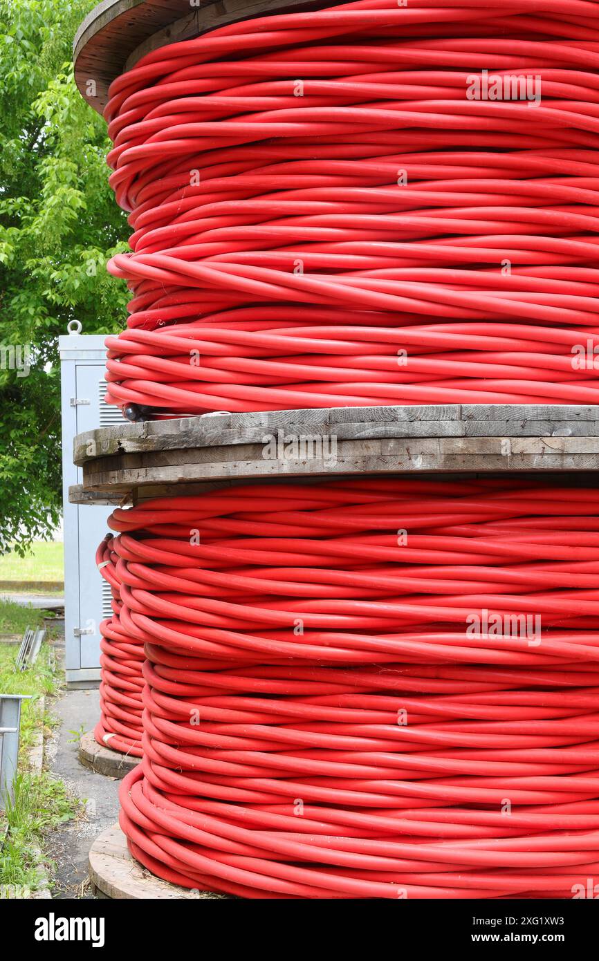 Two massive spools of high-voltage red electrical cable in the power ...