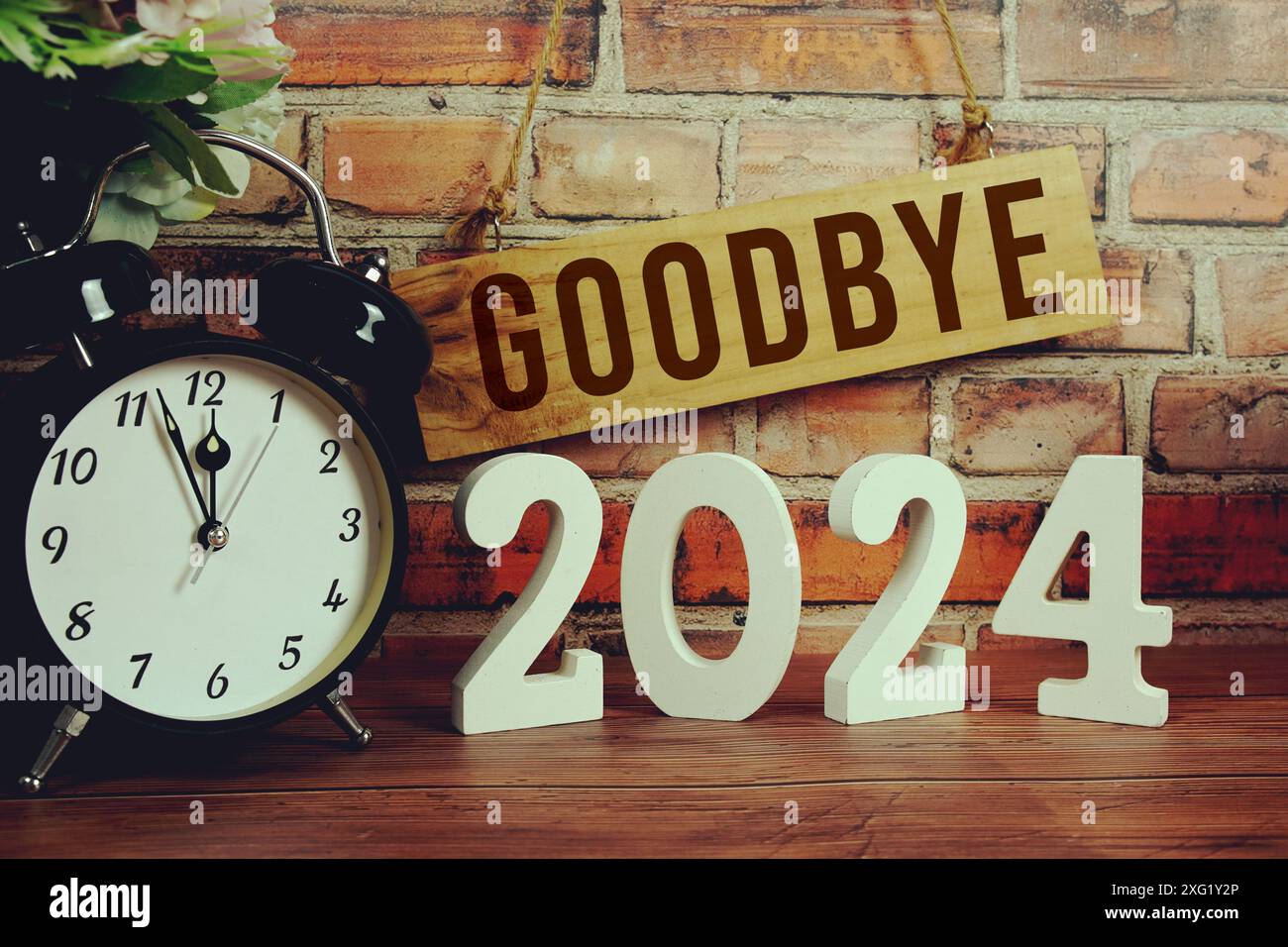 Goodbye 2024 letters with alarm clock on wooden background Stock Photo ...