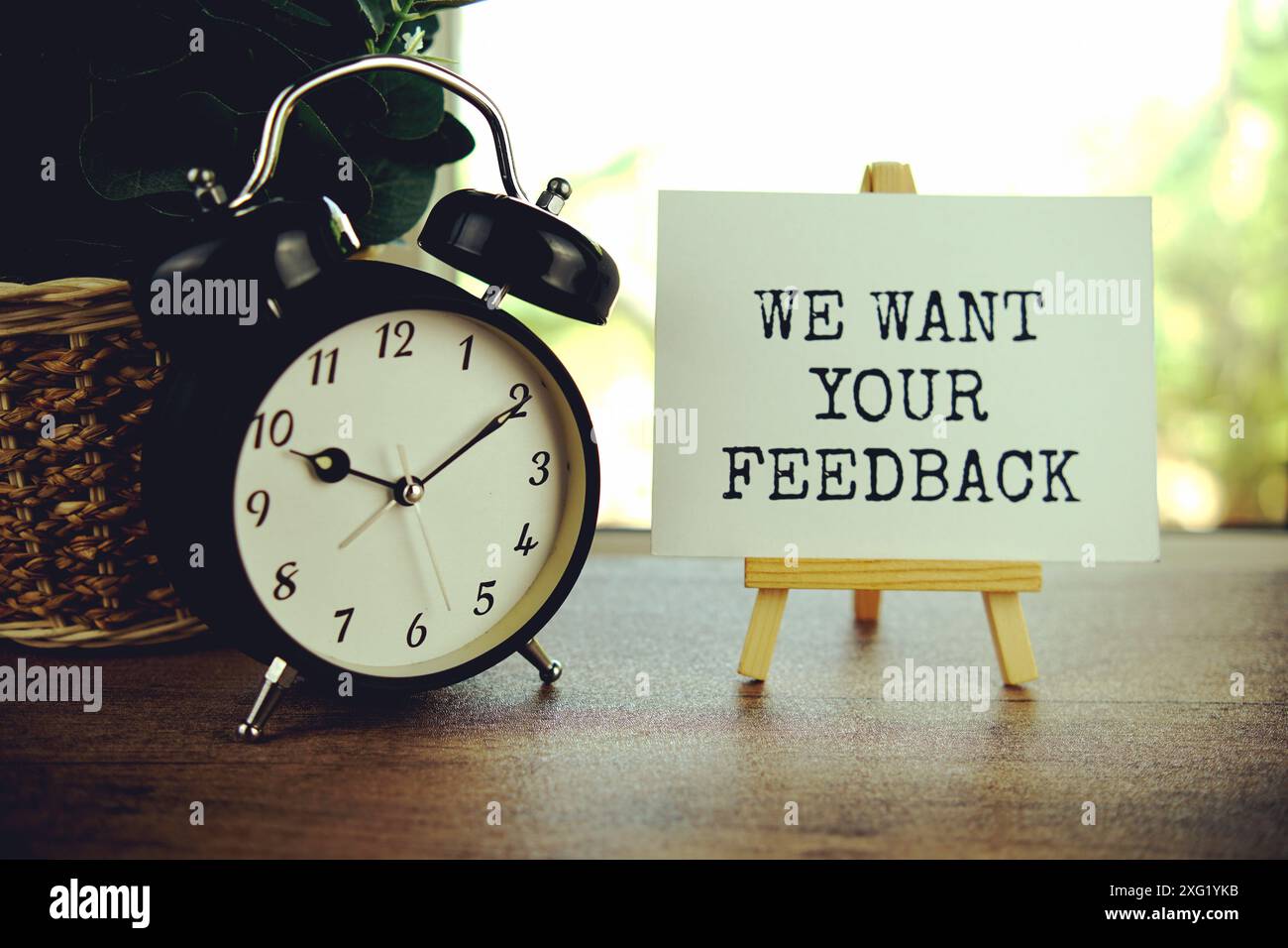 We Want Your Feedback text message on paper card with wooden easel and ...