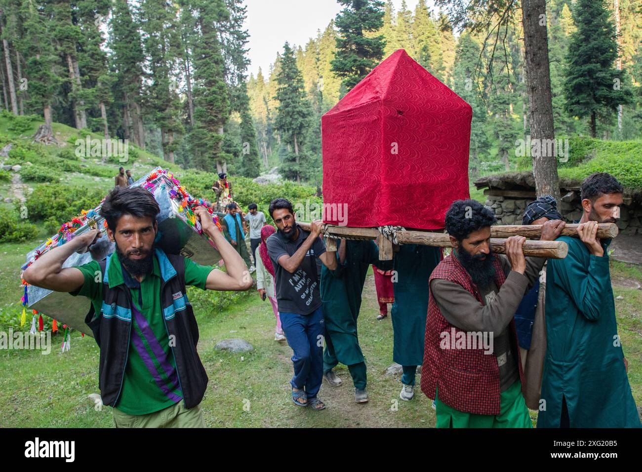 A guest from bride side carrying luggage box as Gujjar (nomad) men ...