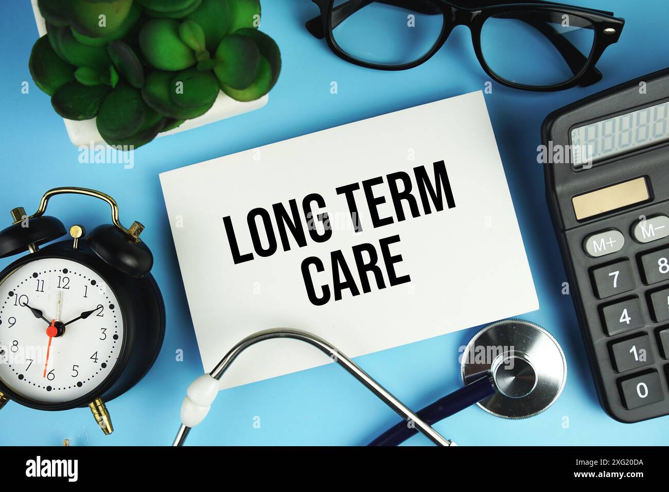 Long term care text with calculator, magnifying glass and alarm clock ...