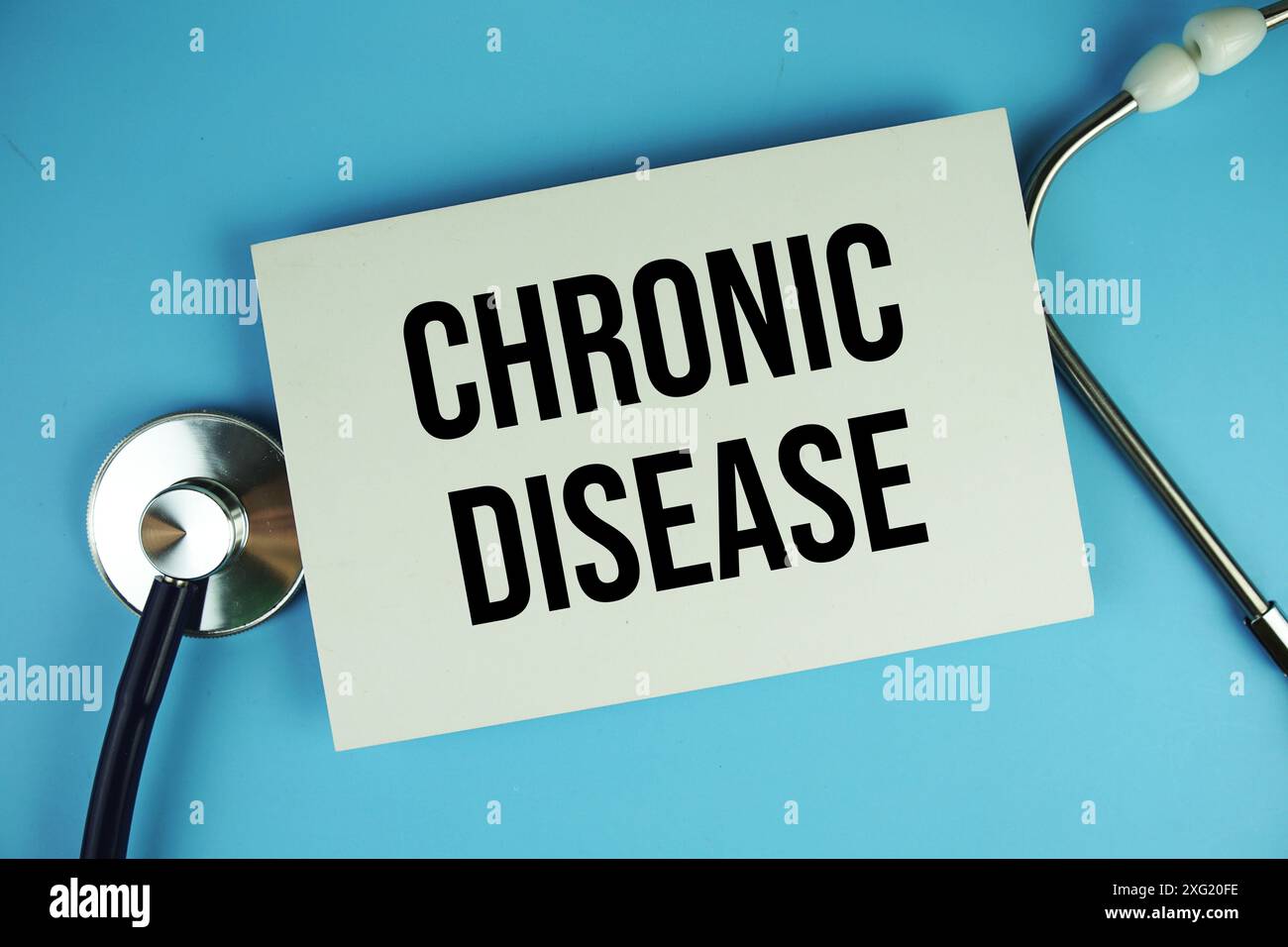 Chronic Disease text on paper card with stethoscope top view on blue ...