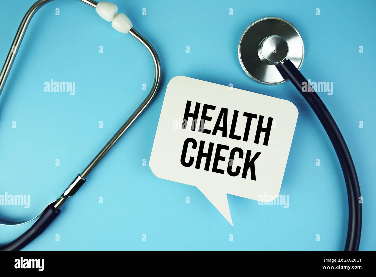 Health Check text on speech bubble with stethoscope top view on blue ...