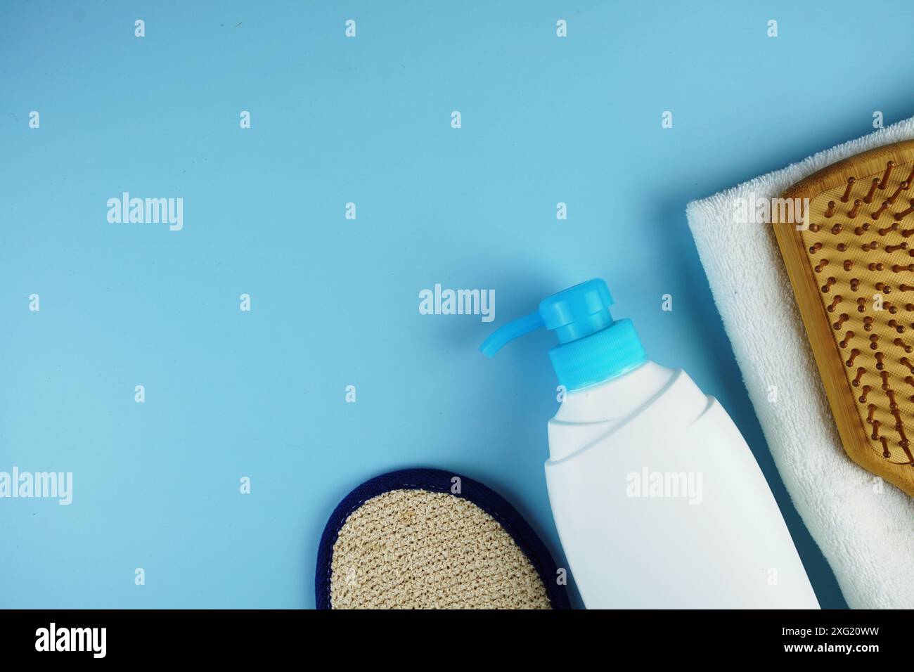 Shampoo bottles, combs and towels Body cleaning equipment on blue ...