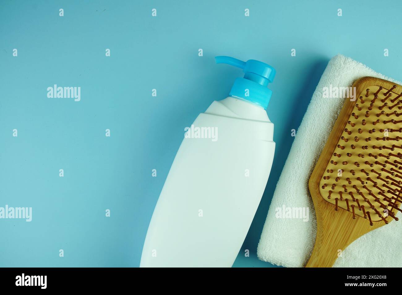 Shampoo bottles, combs and towels Body cleaning equipment on blue ...