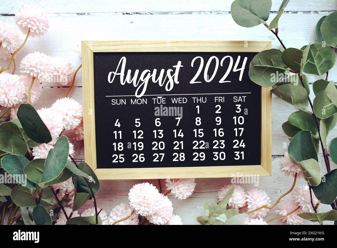 August 2024 monthly calendar with flower bouquet decoration on wooden ...