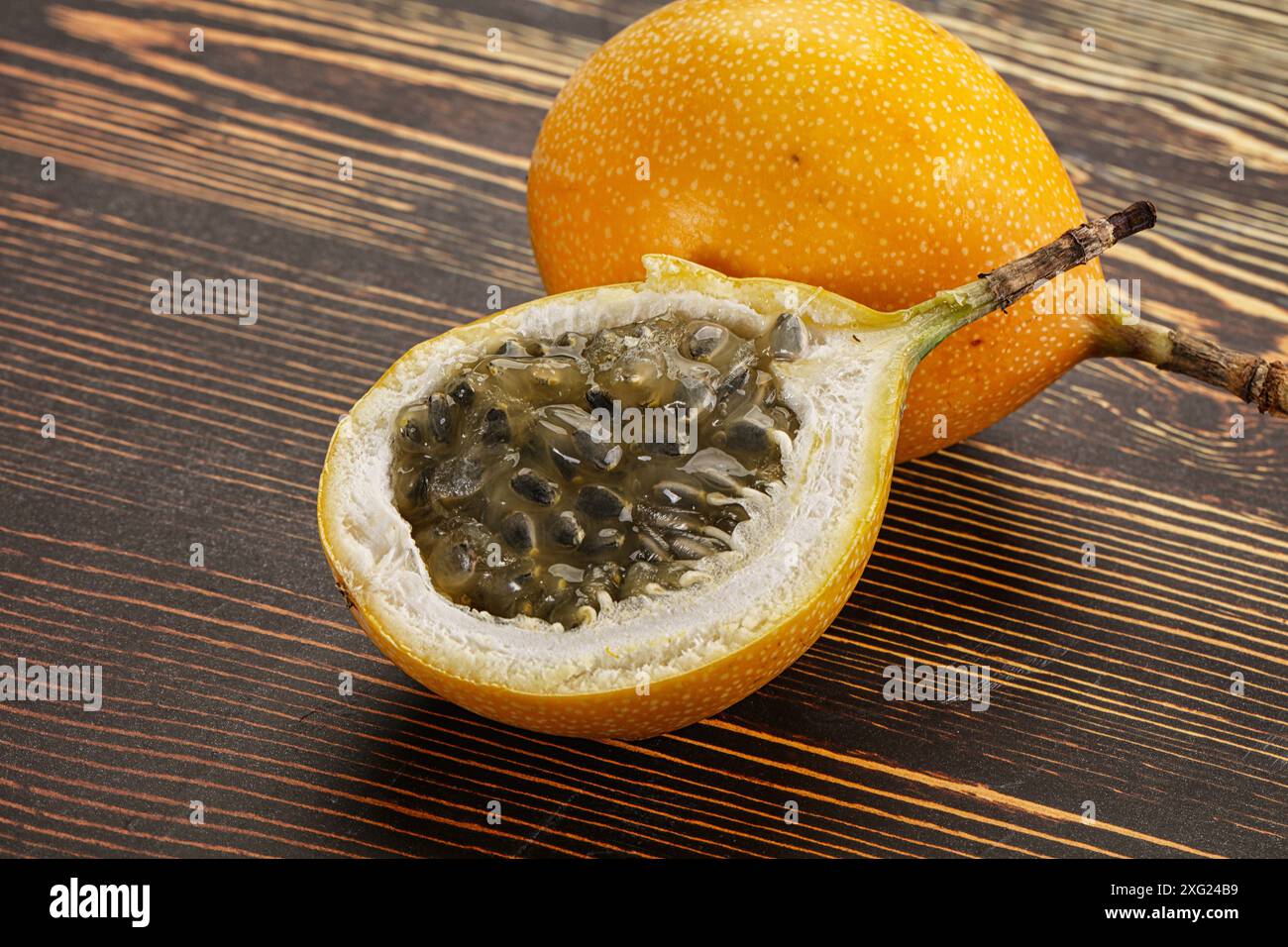 Yellow granadilla fruit with cut half Stock Photo - Alamy