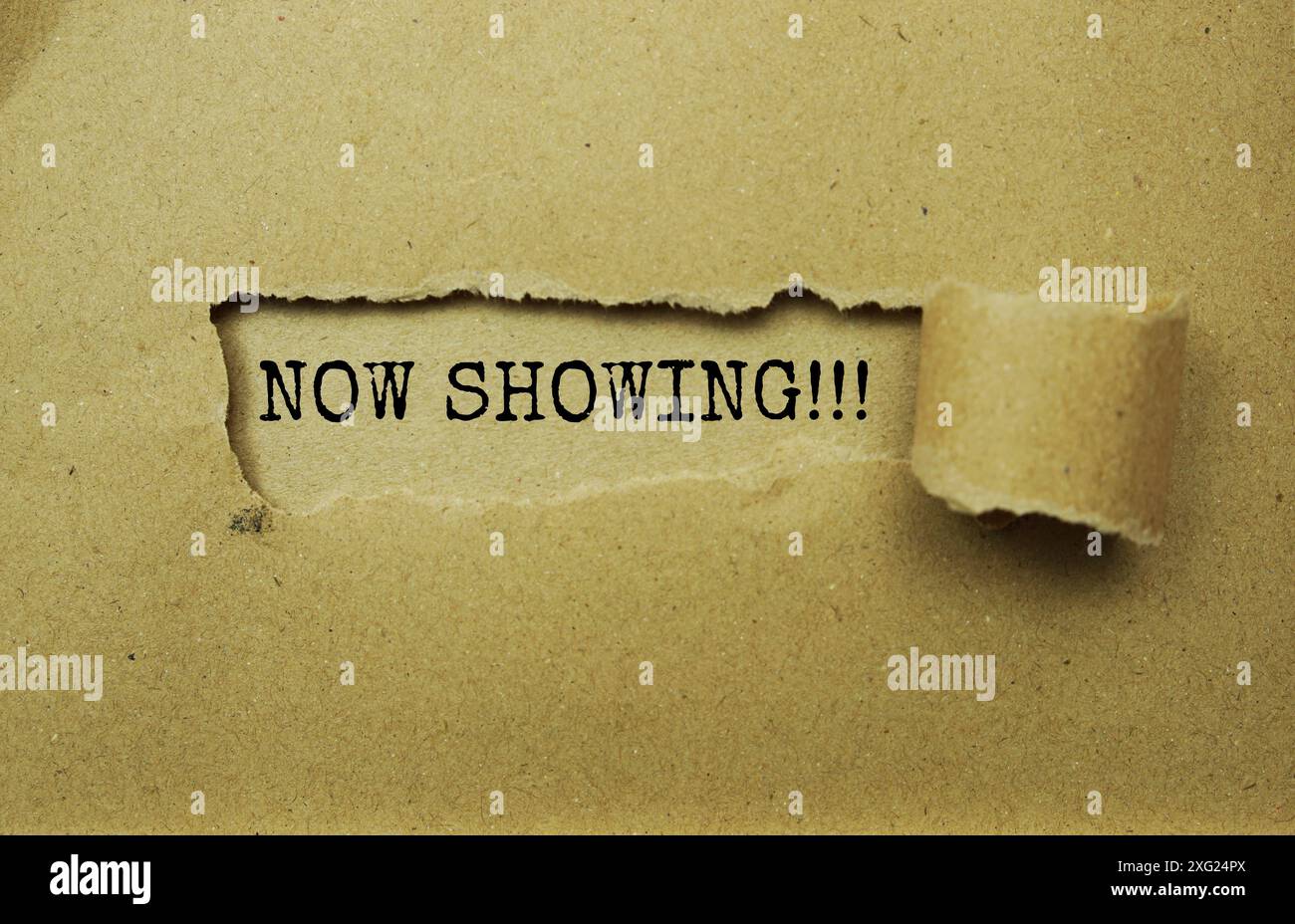 Now Showing message written on craft paper with torn paper background ...