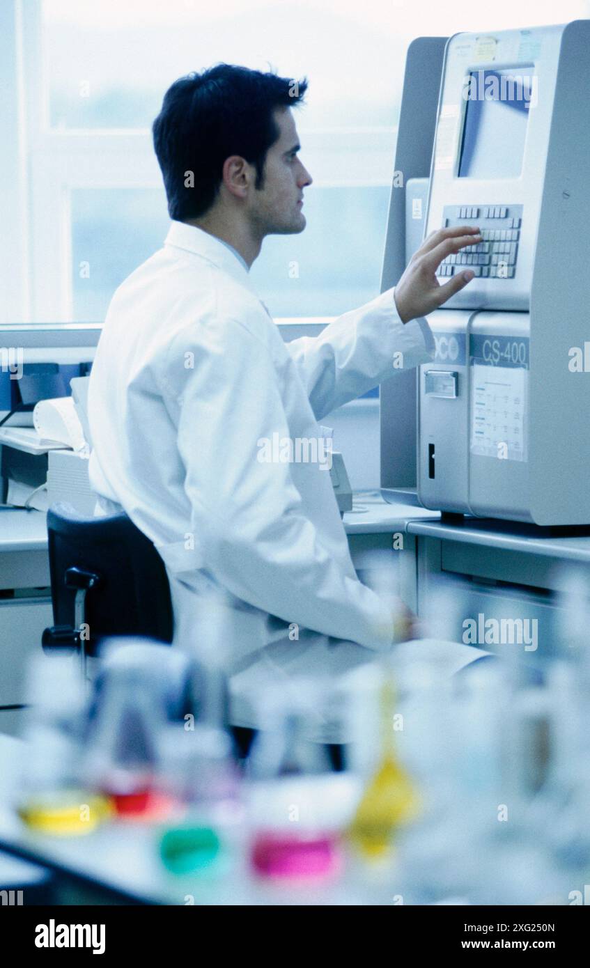 Chemical lab. Chemist using a LECO CS400 automatic carbon/sulphur ...