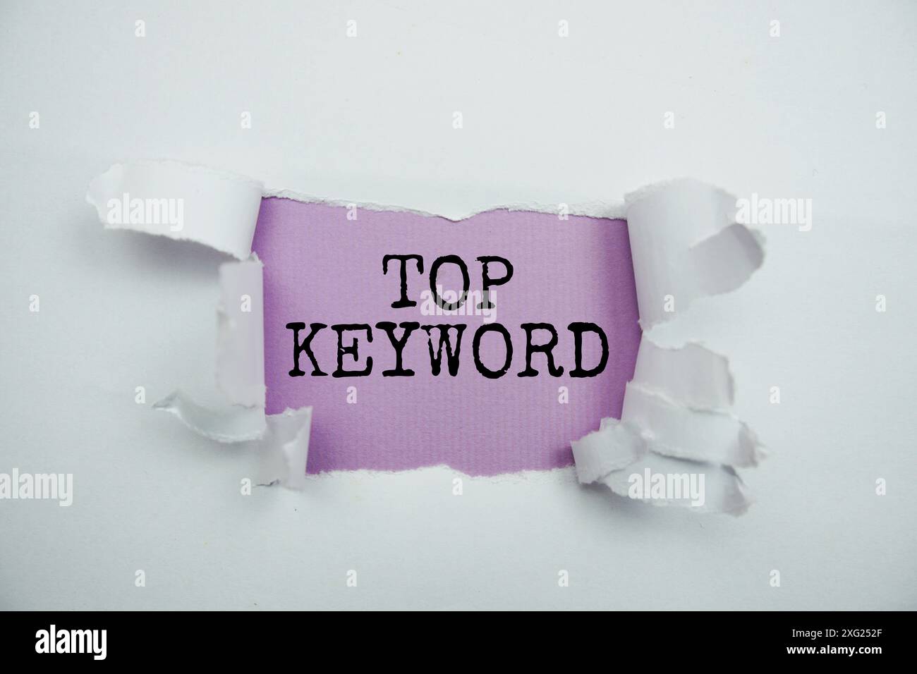 Top Keyword message written on purple paper with torn paper background ...