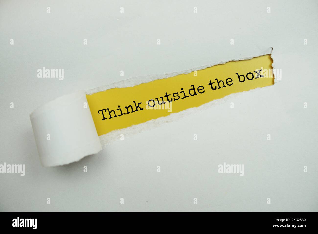 Think Outside The Box message written on yellow paper with torn paper background Stock Photo - Alamy
