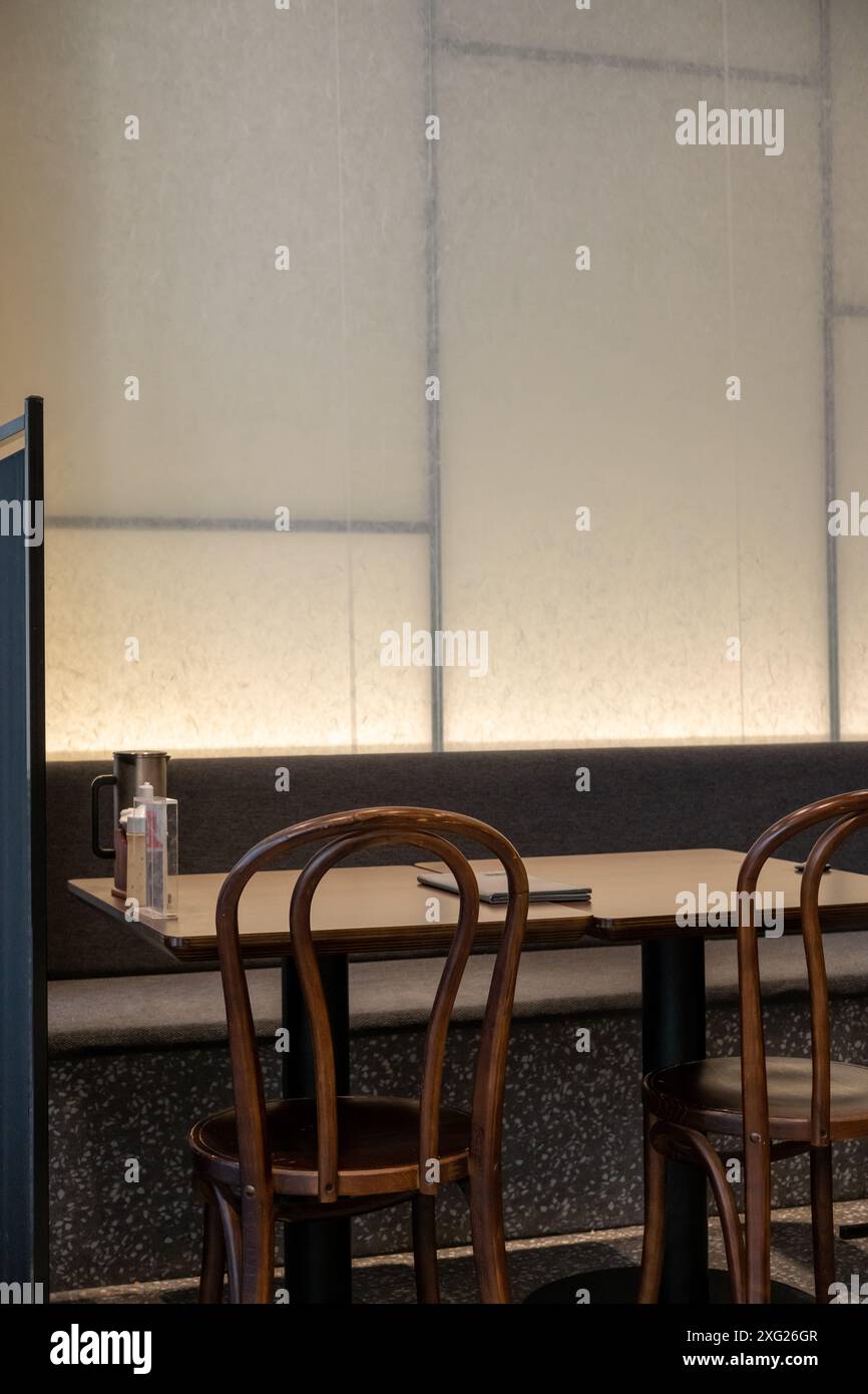 Seating inside the cafe or restaurant, with wooden chairs and table ...